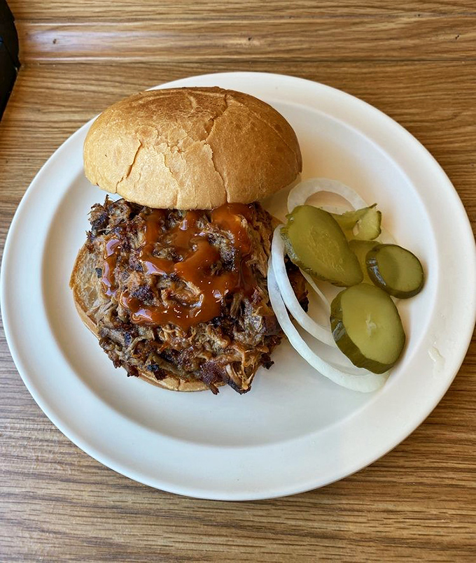 This pulled pork sandwich with its glistening sauce and pickle sidekicks isn't just lunch&mdash;it's an afternoon delight worthy of a detour.