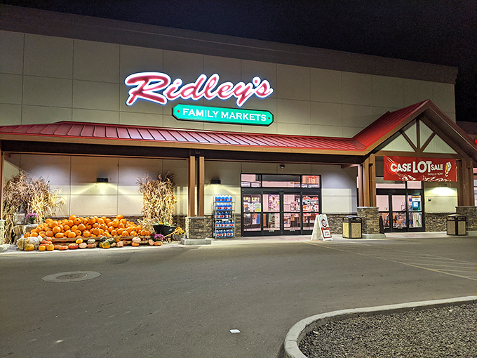 Ridley's stands ready with pumpkins stacked like autumn's own welcome committee, proving grocery stores can have seasonal personality.