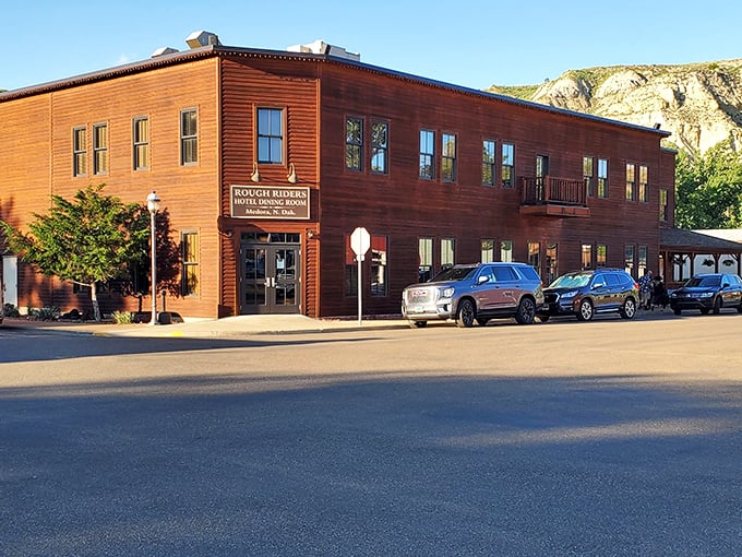 The Rough Riders Hotel stands as a warm wooden welcome to weary travelers, channeling Roosevelt's spirit with every plank and window.