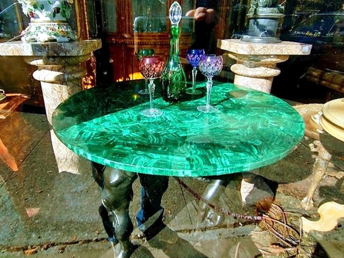 Mother Nature's jewelry box turned tabletop. This malachite masterpiece transforms ordinary dinner conversation into something extraordinary.