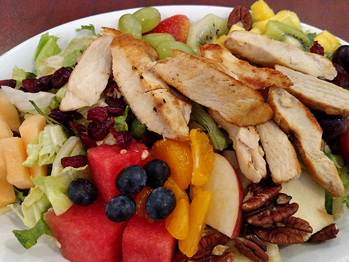 Who says diner food can't be fresh? This vibrant salad topped with grilled chicken proves healthy eating doesn't require sacrificing flavor or satisfaction.