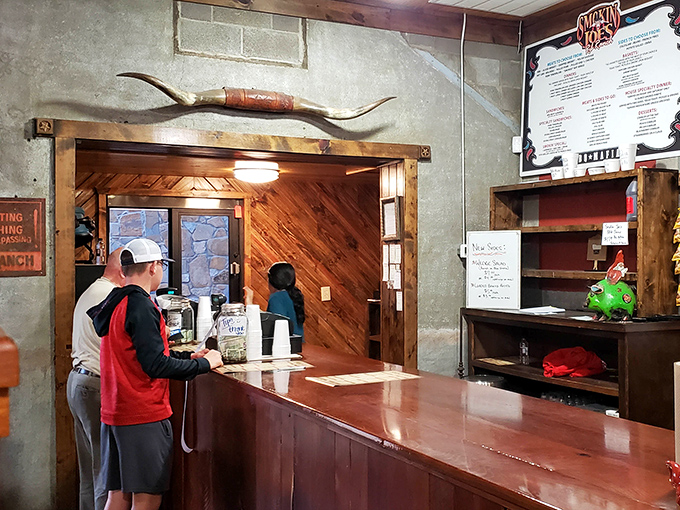 Long horns above the kitchen entrance, because subtlety is overrated when you're serving legendary Texas-style barbecue every day.