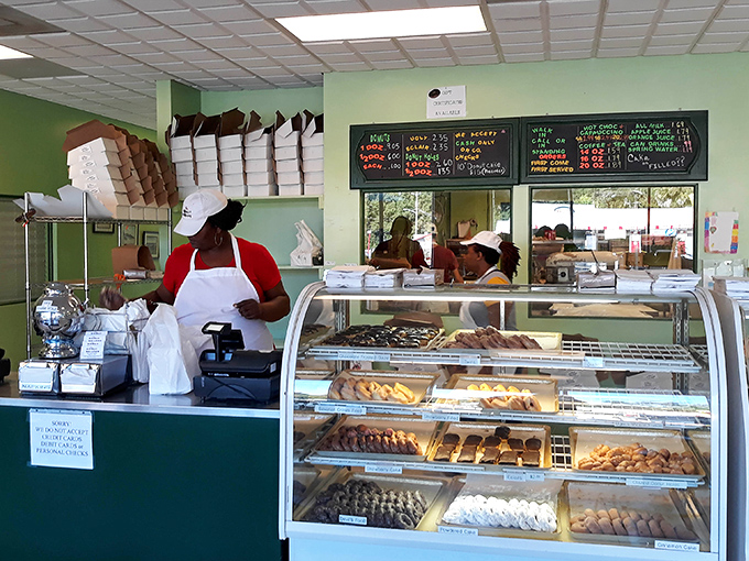 Behind this counter, donut magic happens daily. The display cases showcase an edible art gallery that makes museum-goers and food lovers equally reverent.
