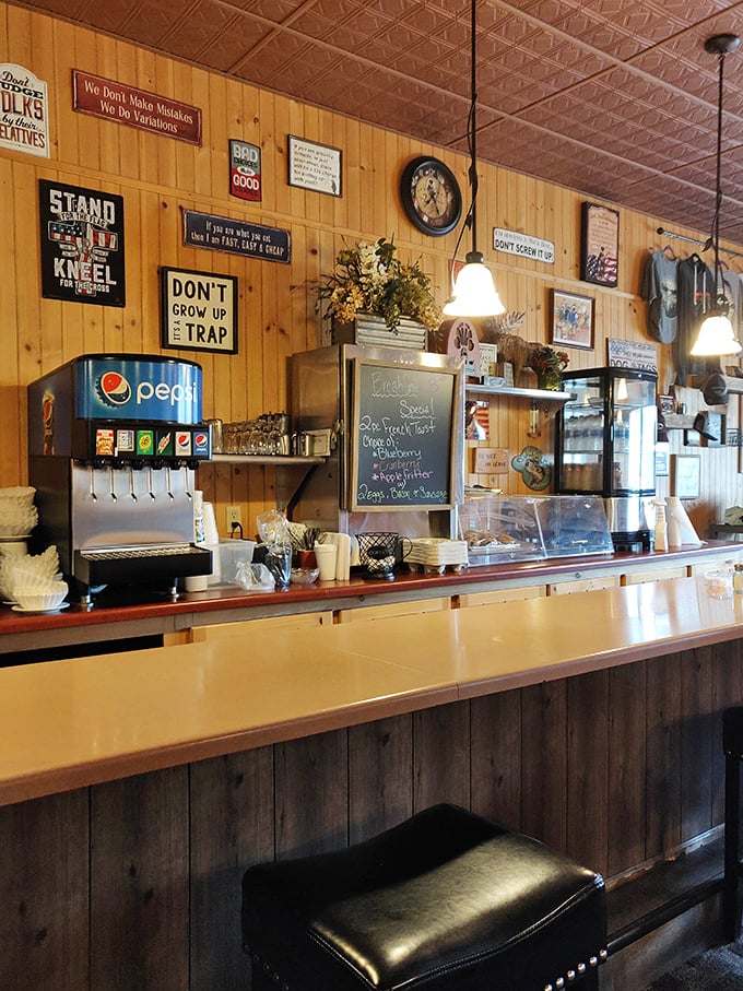 The counter where breakfast magic happens, surrounded by enough quirky signs to keep you entertained through multiple coffee refills.