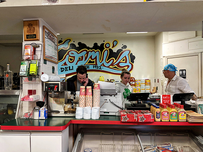 Behind the counter, where sandwich magic happens. The staff works with the precision of surgeons and the creativity of artists to craft each masterpiece.