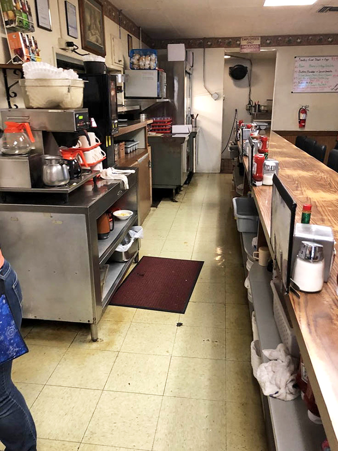 The service counter offers a glimpse into the kitchen's choreography, where comfort food classics are prepared with the precision of a well-oiled machine.