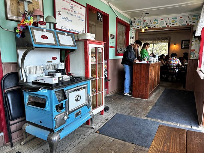 That vintage blue stove isn't just decoration—it's the heart of this establishment, standing proudly beside the service counter like a badge of honor.