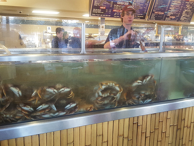 Behind the glass, where the magic happens &ndash; these aren't just employees, they're seafood sommeliers in aprons.