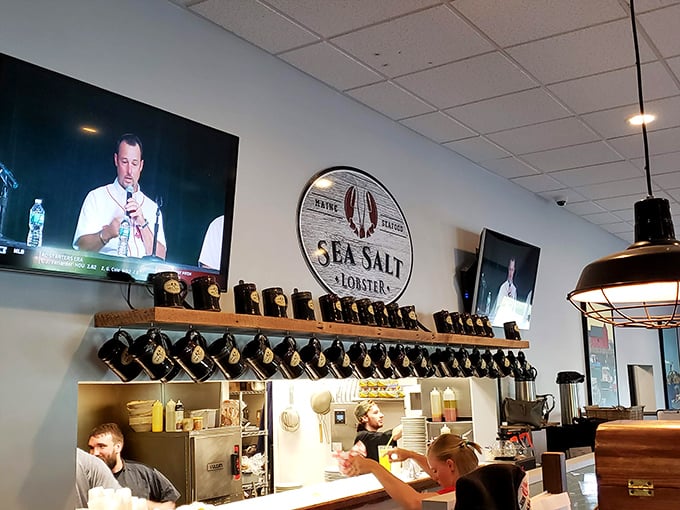 The wall-mounted Sea Salt logo watches over a bustling kitchen where seafood magic happens daily. No smoke and mirrors, just honest cooking.