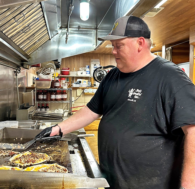 The maestro at work! Where barbecue magic happens, one careful flip at a time. This isn't cooking; it's a relationship with fire and meat.