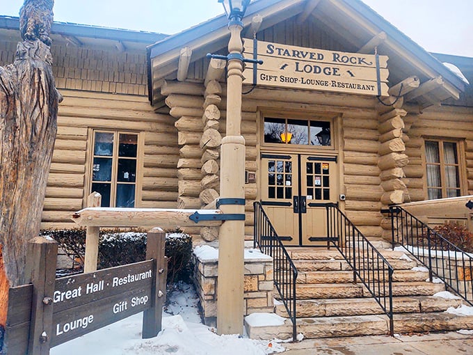 Starved Rock Lodge's rustic log entrance welcomes winter visitors to warm fireplaces and hearty meals with spectacular valley views.