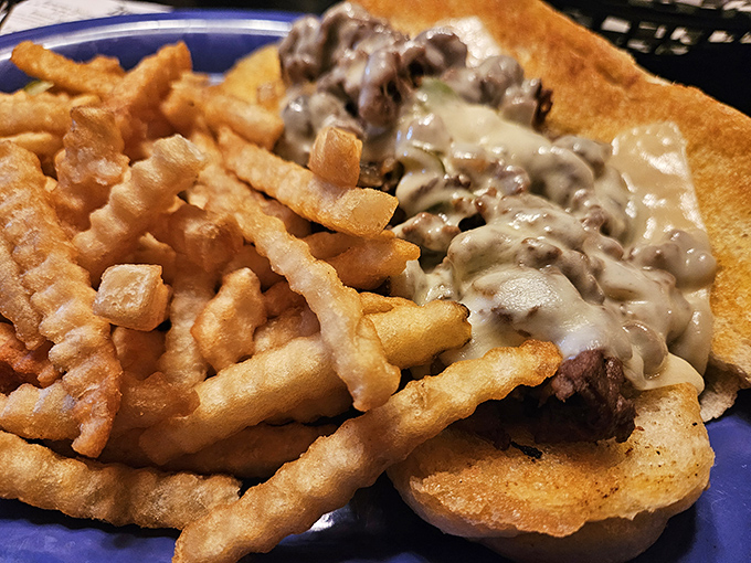 When meat and cheese join forces on bread, creating a sandwich that demands both hands and several napkins.