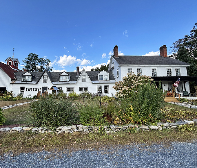 The Stone Hearth Inn stands like a white-painted promise that comfort food and cozy lodging still exist in our hectic world.