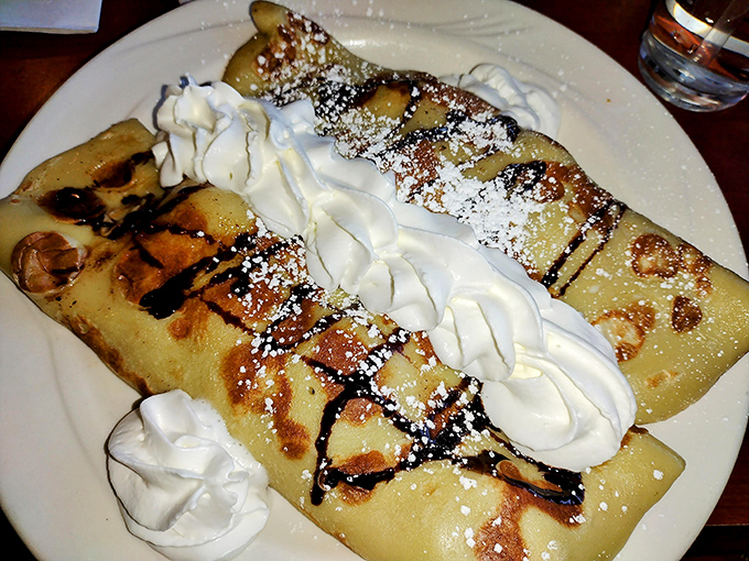 Crepes dressed for success with whipped cream and chocolate drizzle&mdash;breakfast's answer to formal wear.