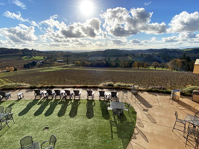 Terrace seating transforms wine tasting into outdoor theater with the Willamette Valley as backdrop.