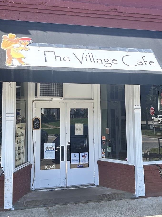 The Village Cafe's charming storefront promises the kind of comfort food that makes you want to hug the cook afterward.