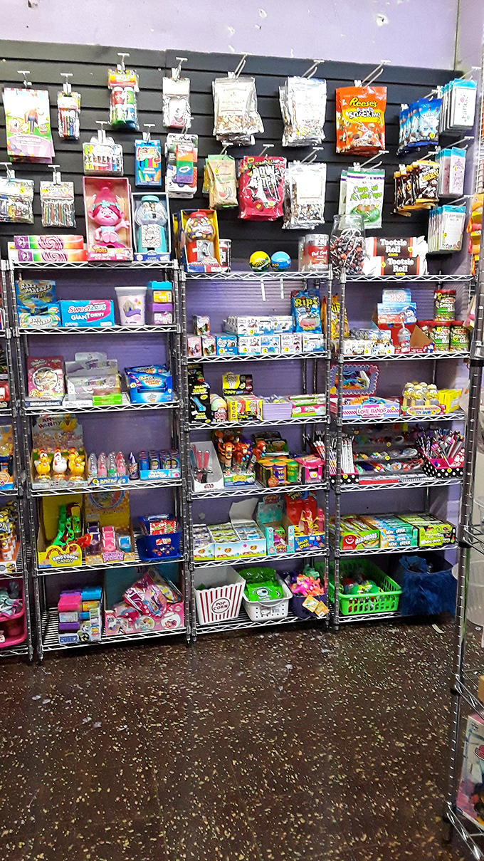 Sugar rush paradise! This candy booth's rainbow display and balloon arch would make Willy Wonka himself stop for a sweet souvenir.