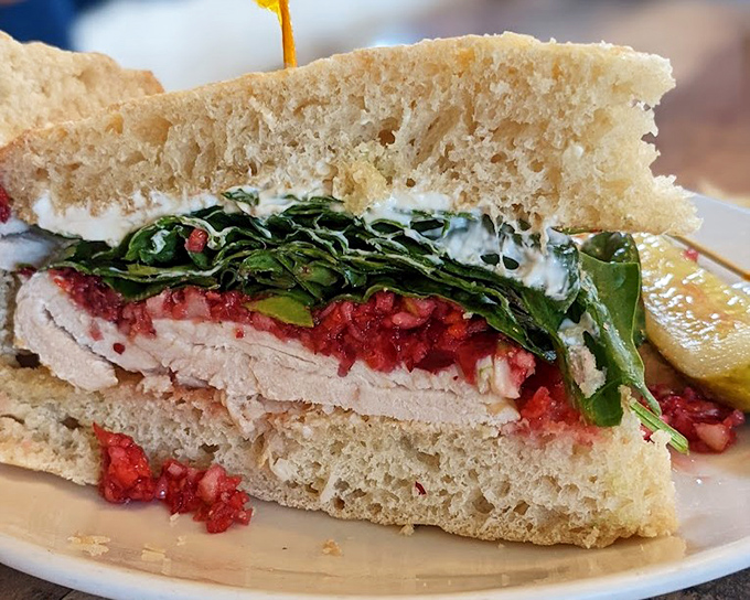 Turkey meets cranberry in this sandwich love story. The greens aren't just healthy—they're the perfect supporting characters in this bread-bound drama.