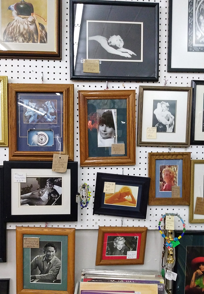 A wall of framed memories featuring faces that defined generations of style, music, and culture.