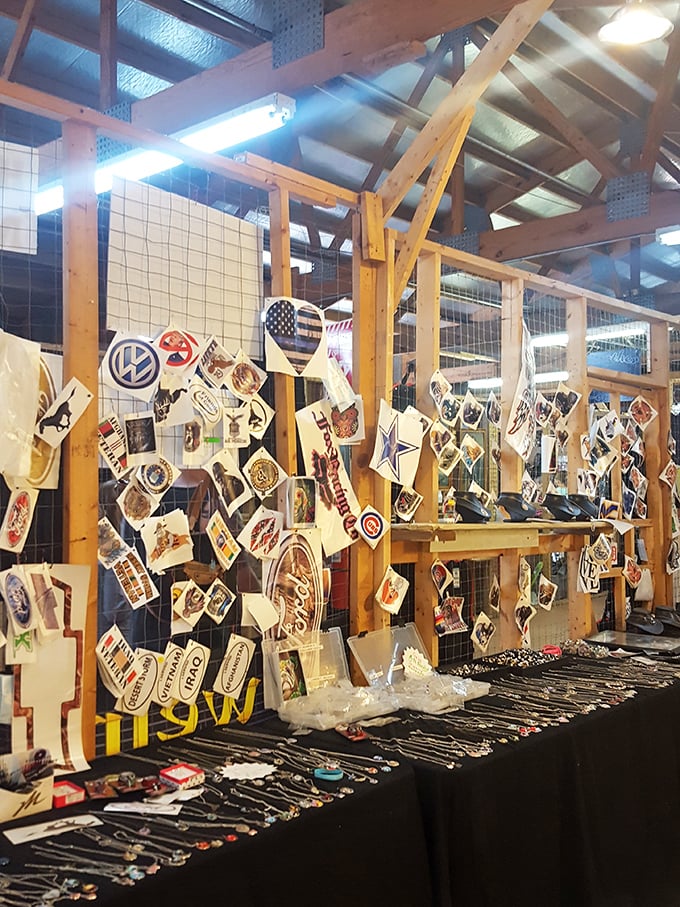 A patchwork of stickers and dangling necklaces transforms wire fencing into a gallery of personal expression and road trip memories.