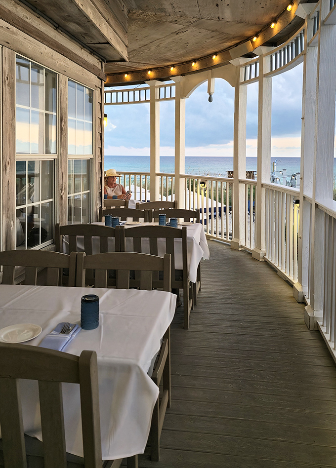 The veranda dining area where string lights, ocean breezes, and white tablecloths conspire to create perfect dinner memories.