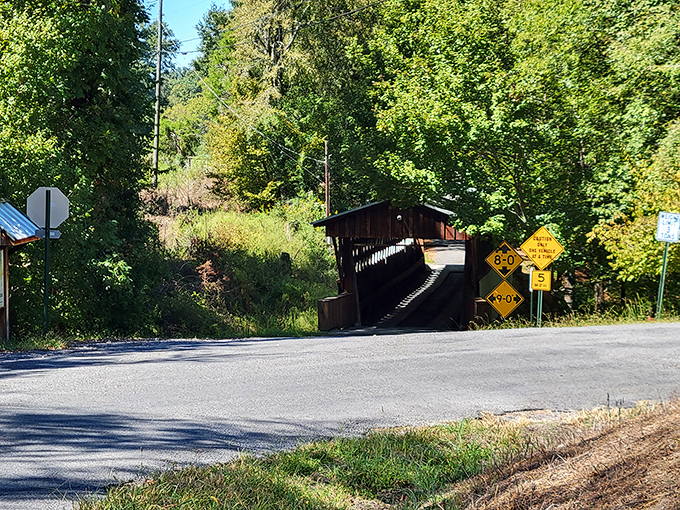 Approaching the bridge feels like discovering a secret passage&mdash;yellow signs warning tall vehicles that this historical doorway has height restrictions.