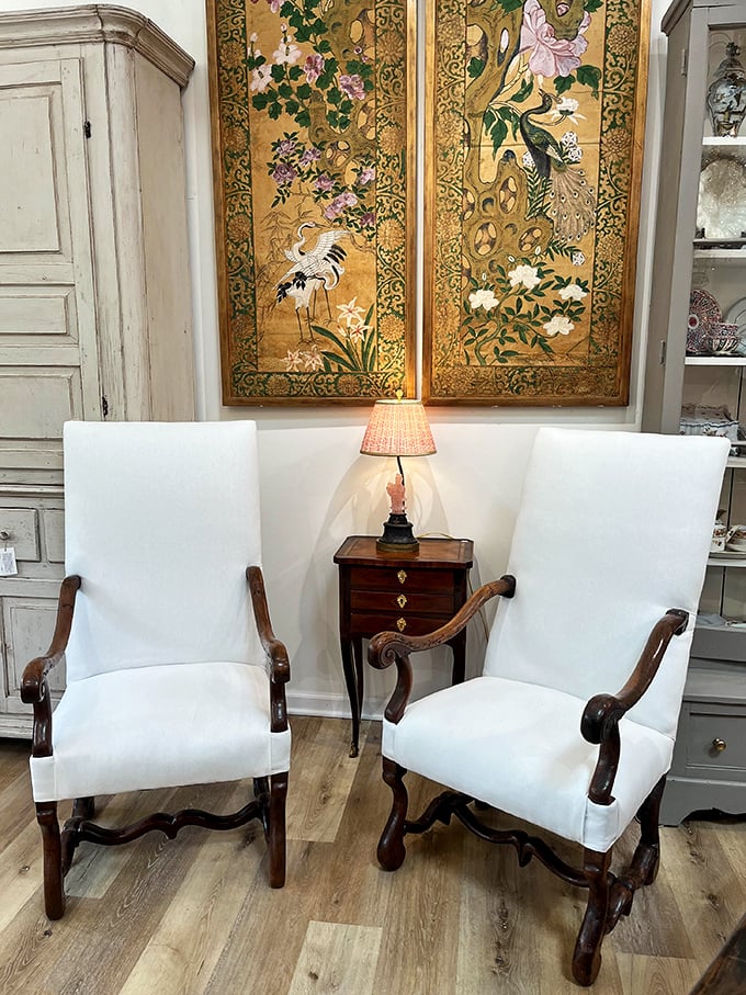 Two chairs having a conversation about elegance. The Asian-inspired panels behind them are silently judging your home decor choices.