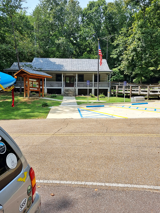 The visitor center stands ready to welcome explorers, its classic design blending harmoniously with the surrounding woodland.