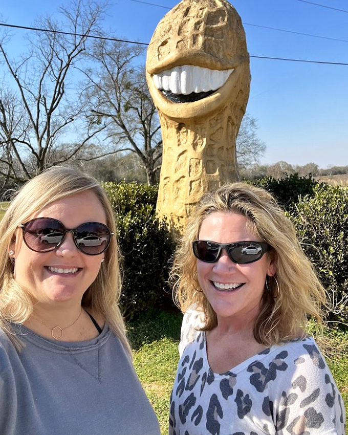 Two friends share a laugh with Plains' most photogenic resident, creating memories worth the detour.
