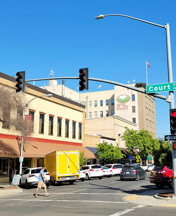 Downtown intersections buzz with the energy of local commerce, where historic buildings house modern businesses under the watchful eye of the Bank of the Sierra.
