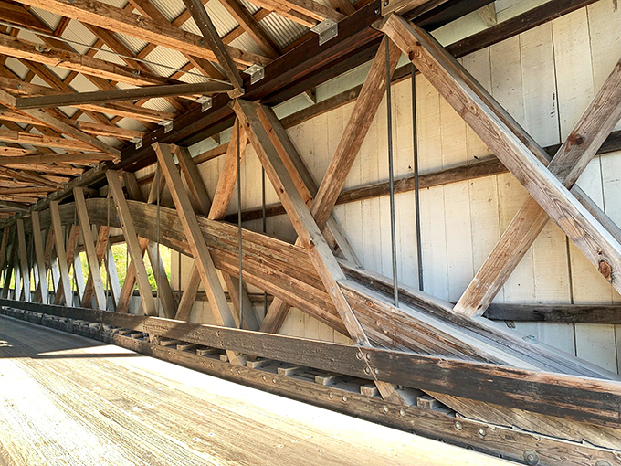 The interior reveals a wooden skeleton of precise engineering &ndash; each beam and brace working in harmony like a well-rehearsed orchestra of timber.