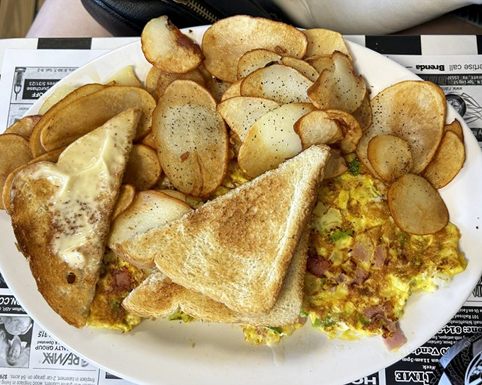 A Western omelet so loaded with ingredients it needs its own zip code and possibly a forklift.