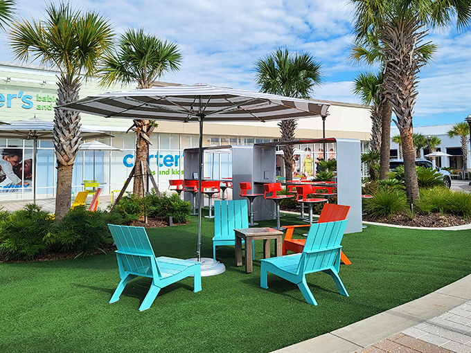 Adirondack chairs in beachy hues create the perfect shopping intermission. The outlet mall's version of a pit stop—colorful, inviting, and strategically placed.