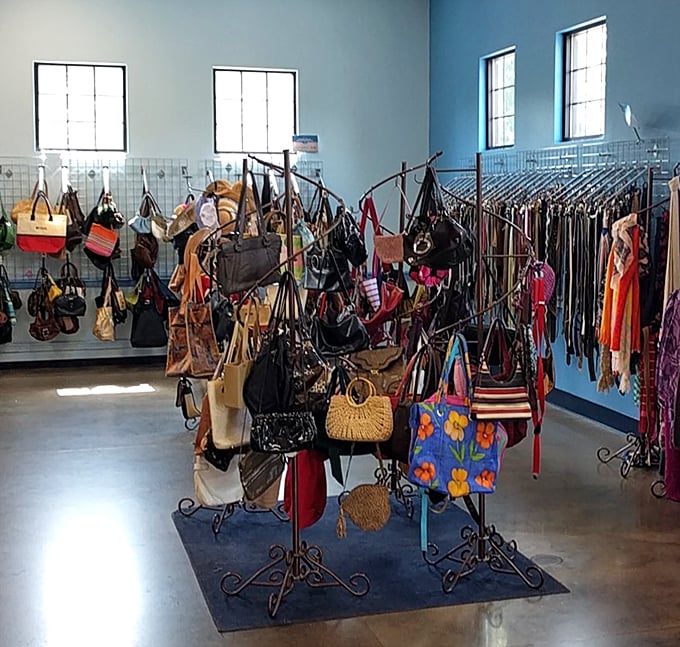 Handbag heaven unfolds on spinning racks, where designer dreams and practical purses hang in democratic harmony.