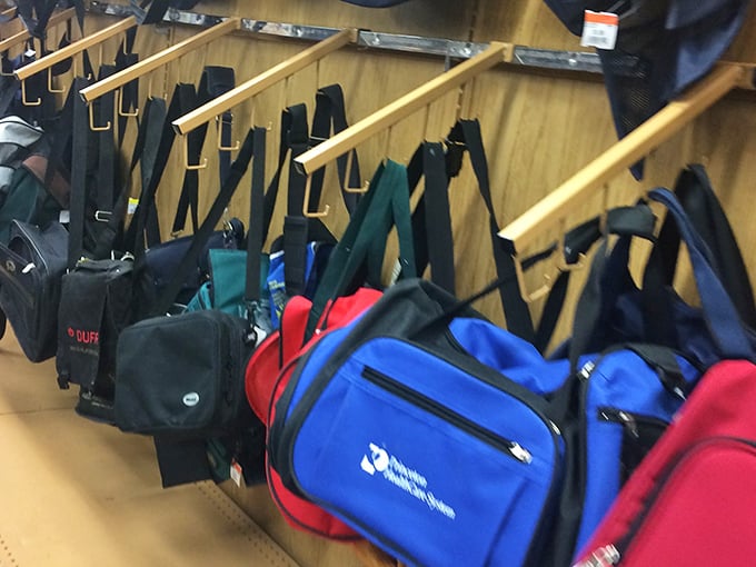 The bag section: where retired corporate logos and forgotten conference swag find new purpose in grocery runs and gym visits.