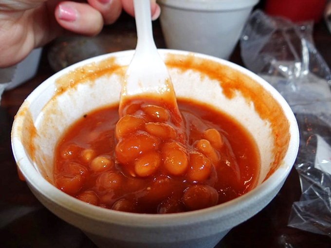Baked beans swimming in a sauce that's part molasses, part magic. Each spoonful is a sweet-savory revelation.