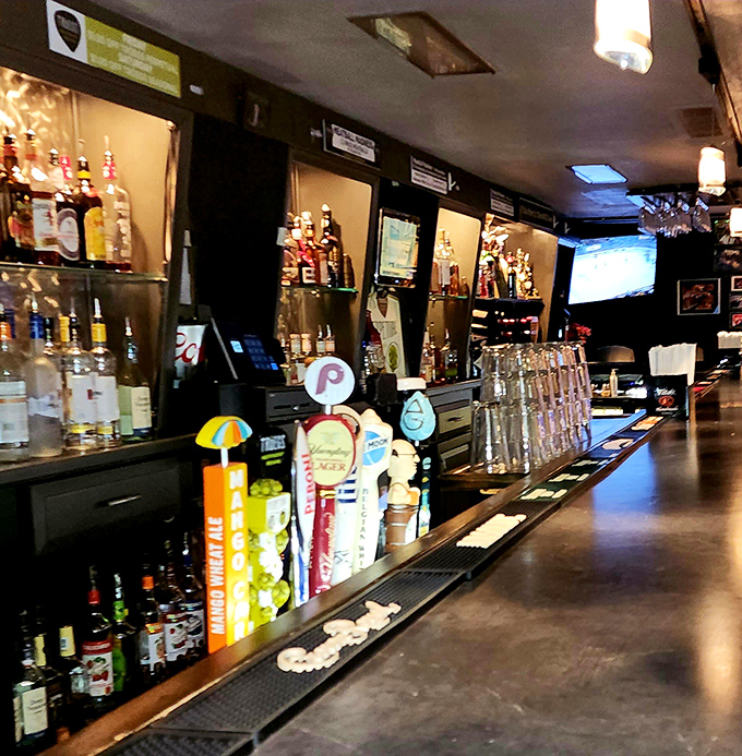 The bar at Fenicci's stands ready to pour liquid happiness, whether your preference runs to craft beer or classic cocktails.