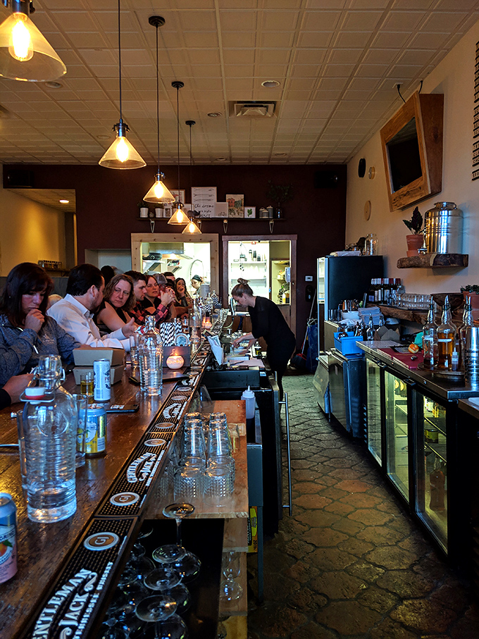 The bar isn't just where drinks are made—it's command central for liquid happiness, where glassware gleams with promise and every bottle tells a story.