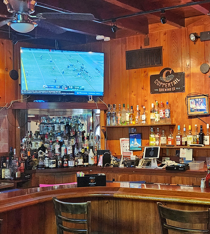 The full-service bar area where fishing tales grow taller with each round. Those wood-paneled walls have heard some stories! 