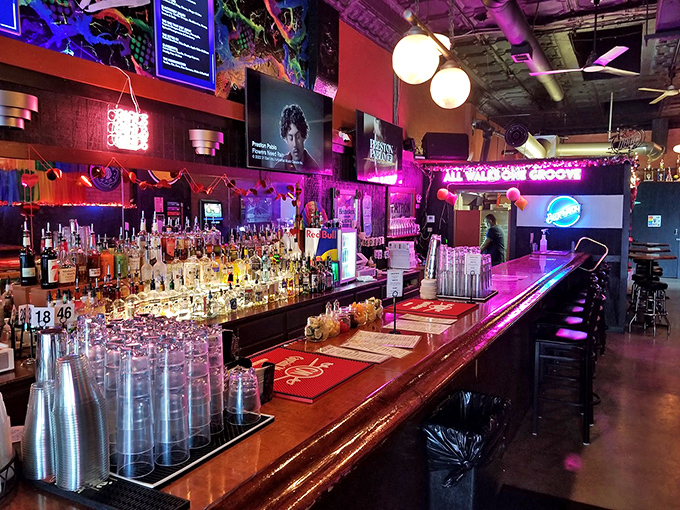 The bar gleams with promise, bottles standing at attention like soldiers ready to serve in the battle against ordinary nights out.