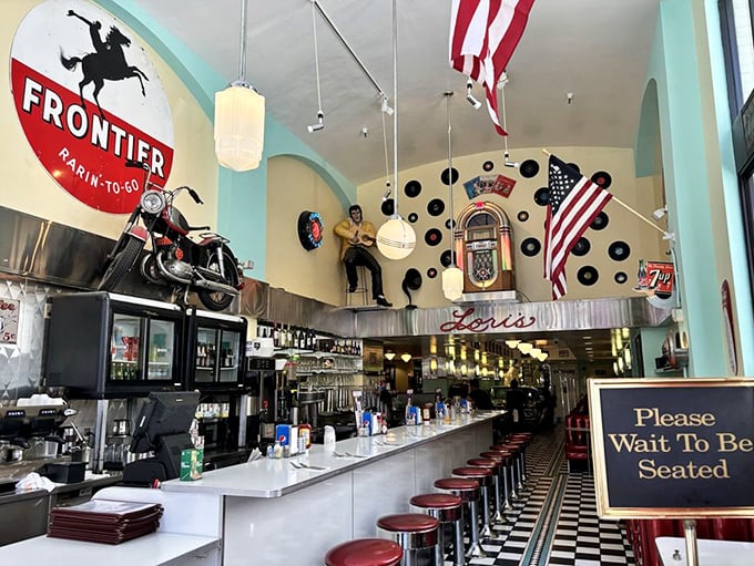 The bar area channels pure Americana with its jukebox, motorcycle, and enough vintage signs to open a small museum.