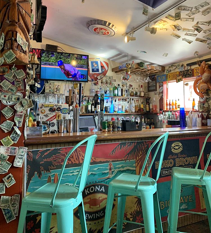 The bar area where dollars decorate the ceiling and stories flow as freely as the drinks. A shrine to good times where strangers quickly become friends.