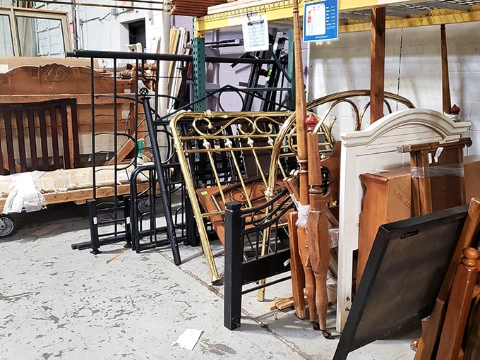 Bed frames and headboards lean against each other like old friends at a reunion, each with character etched into every curve and corner.