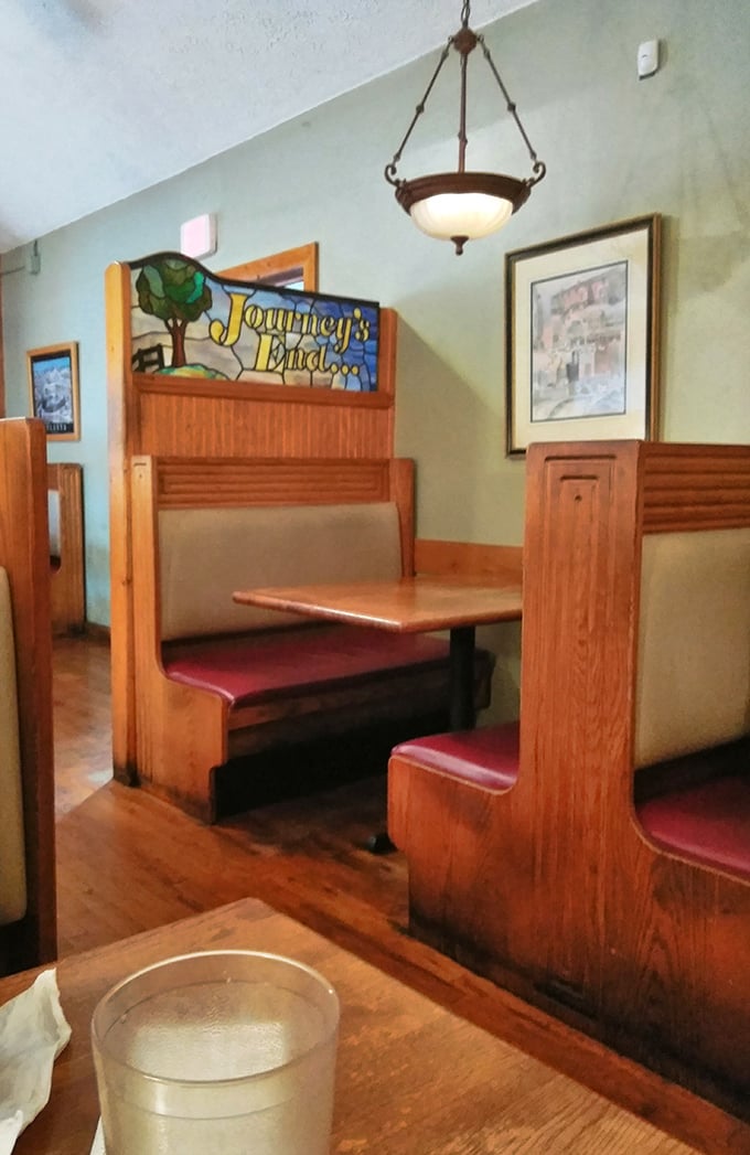 Booth seating with stained glass accents adds unexpected charm&mdash;like finding out your plain-speaking uncle secretly writes beautiful poetry.