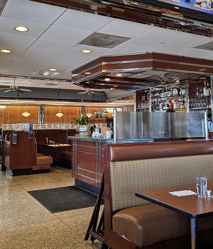 The dining room balances retro charm with comfortable practicality, where burgundy booths have cradled generations of hungry patrons sharing life over pie.