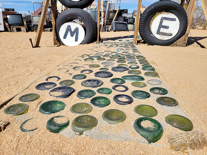A pathway paved with glass bottoms (not boats) leads to giant tire letters &ndash; proving one person's trash truly is another's artistic treasure.