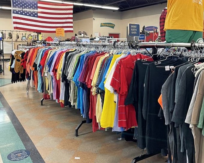 American pride watches over a rainbow of shirts. That yellow tee practically screams "I'll be your favorite weekend companion!"
