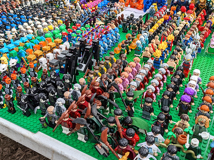 An army of tiny plastic people standing at attention, organized by color like the world's most orderly rainbow. Childhood nostalgia sold by the square foot.