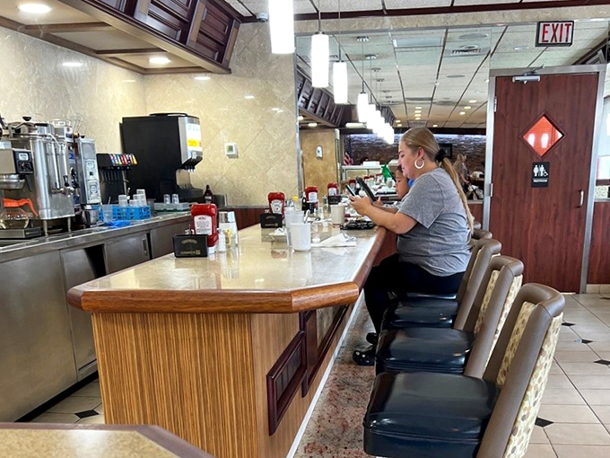 Counter seating where coffee flows freely and strangers might just become your new favorite breakfast companions tomorrow morning.