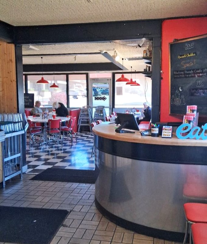 The counter where magic happens &ndash; where orders are called, coffee is poured, and the staff choreographs the perfect diner ballet throughout the day.